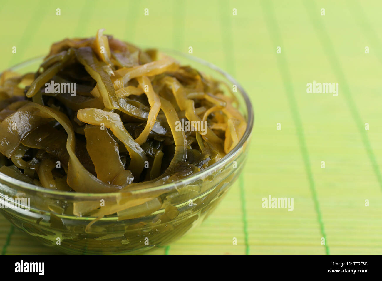 Seaweed in glass bowl on bamboo mat background Stock Photo - Alamy