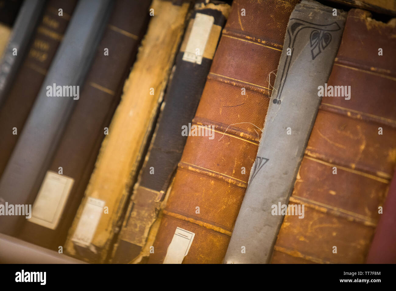 Color image of some old books on a shelf Stock Photo - Alamy