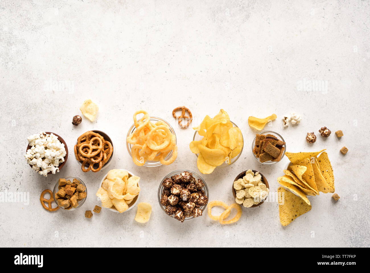 Assortment of Unhealthy Snacks: chips, popcorn, nachos, pretzels, onion ...