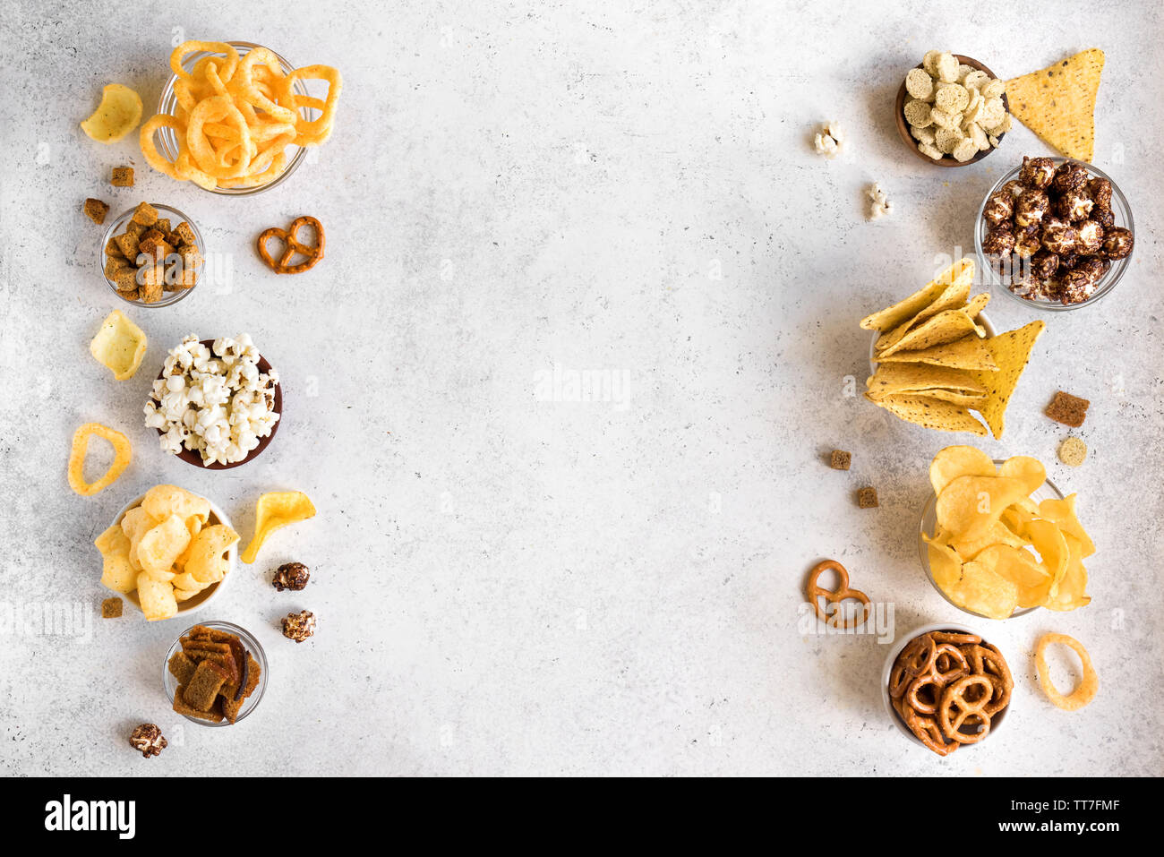 Assortment of Unhealthy Snacks: chips, popcorn, nachos, pretzels, onion ...
