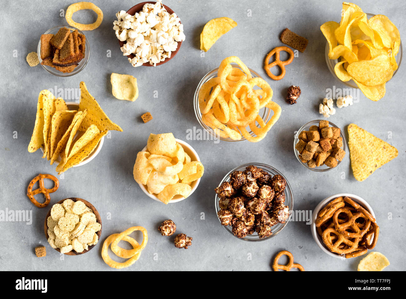 Assortment of Unhealthy Snacks: chips, popcorn, nachos, pretzels, onion ...