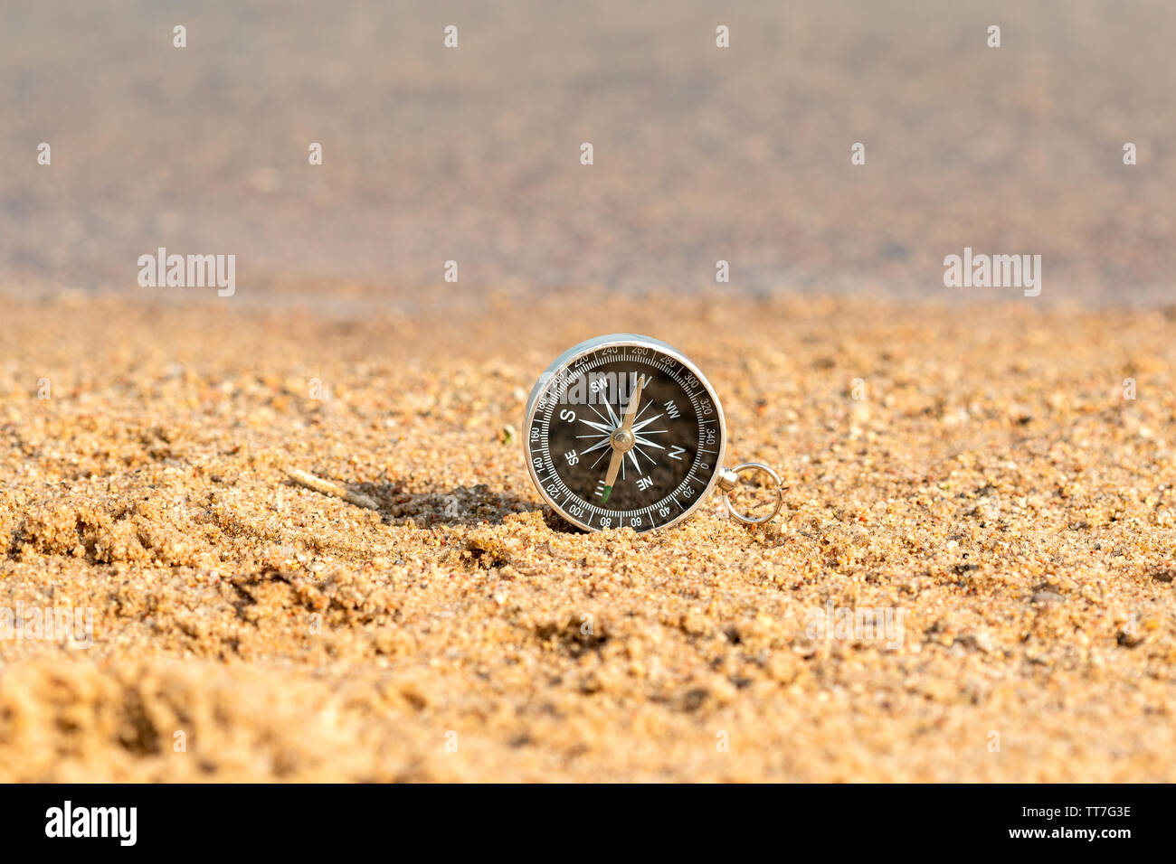 Compass on the beach with sunshine in the morning Stock Photo - Alamy