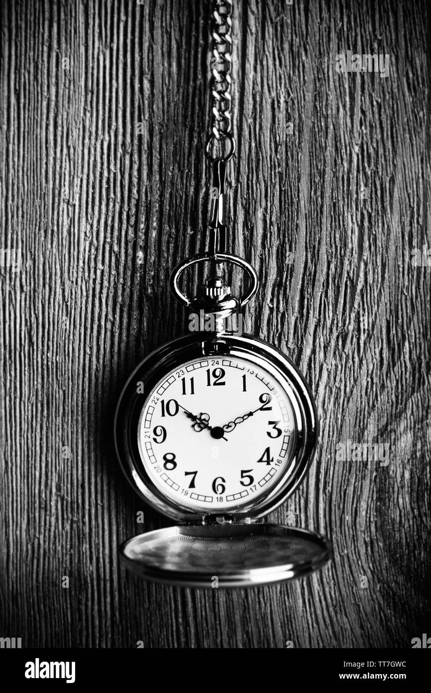 Silver pocket clock on wooden background Stock Photo - Alamy