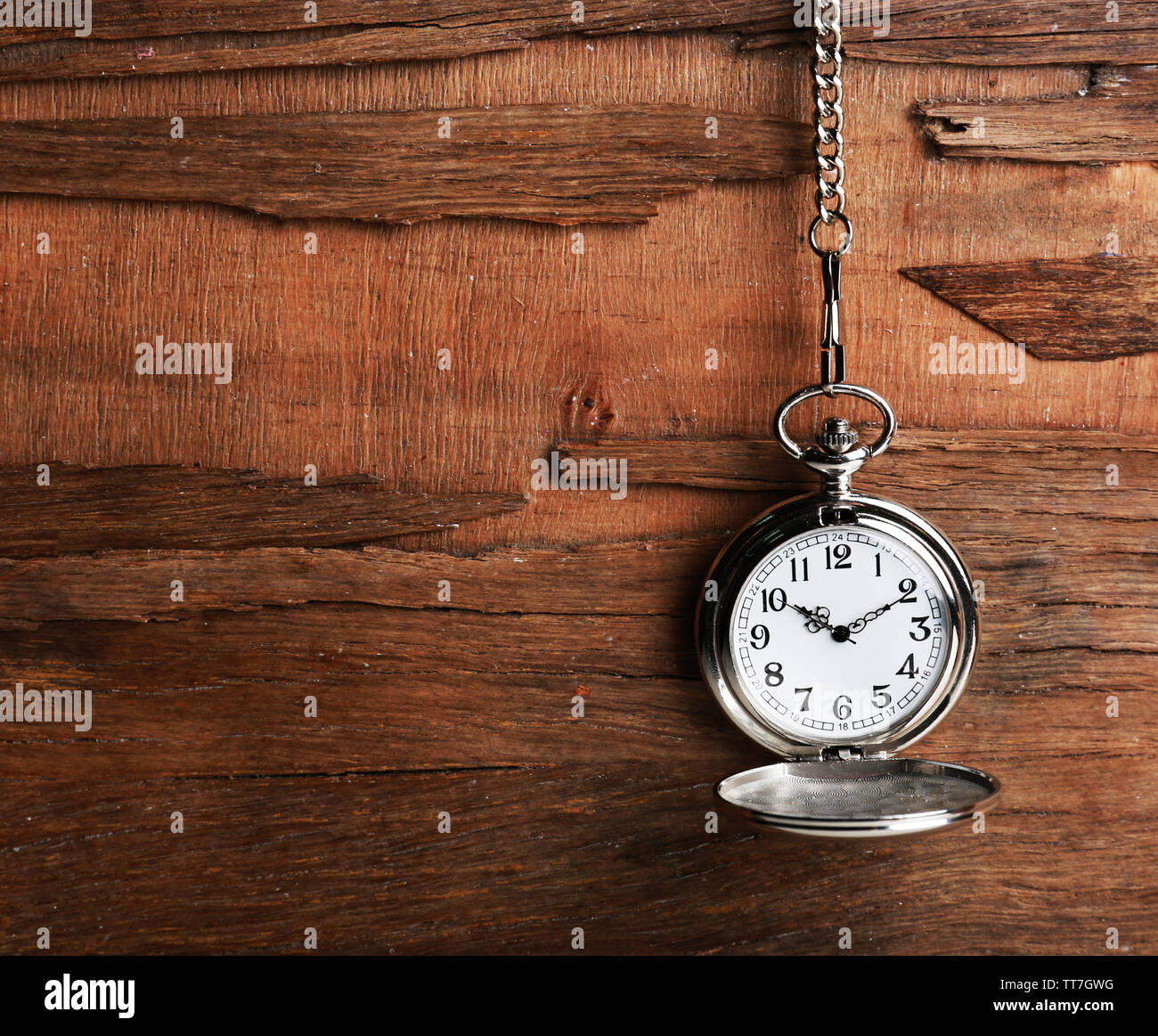 Silver pocket clock on wooden background Stock Photo - Alamy