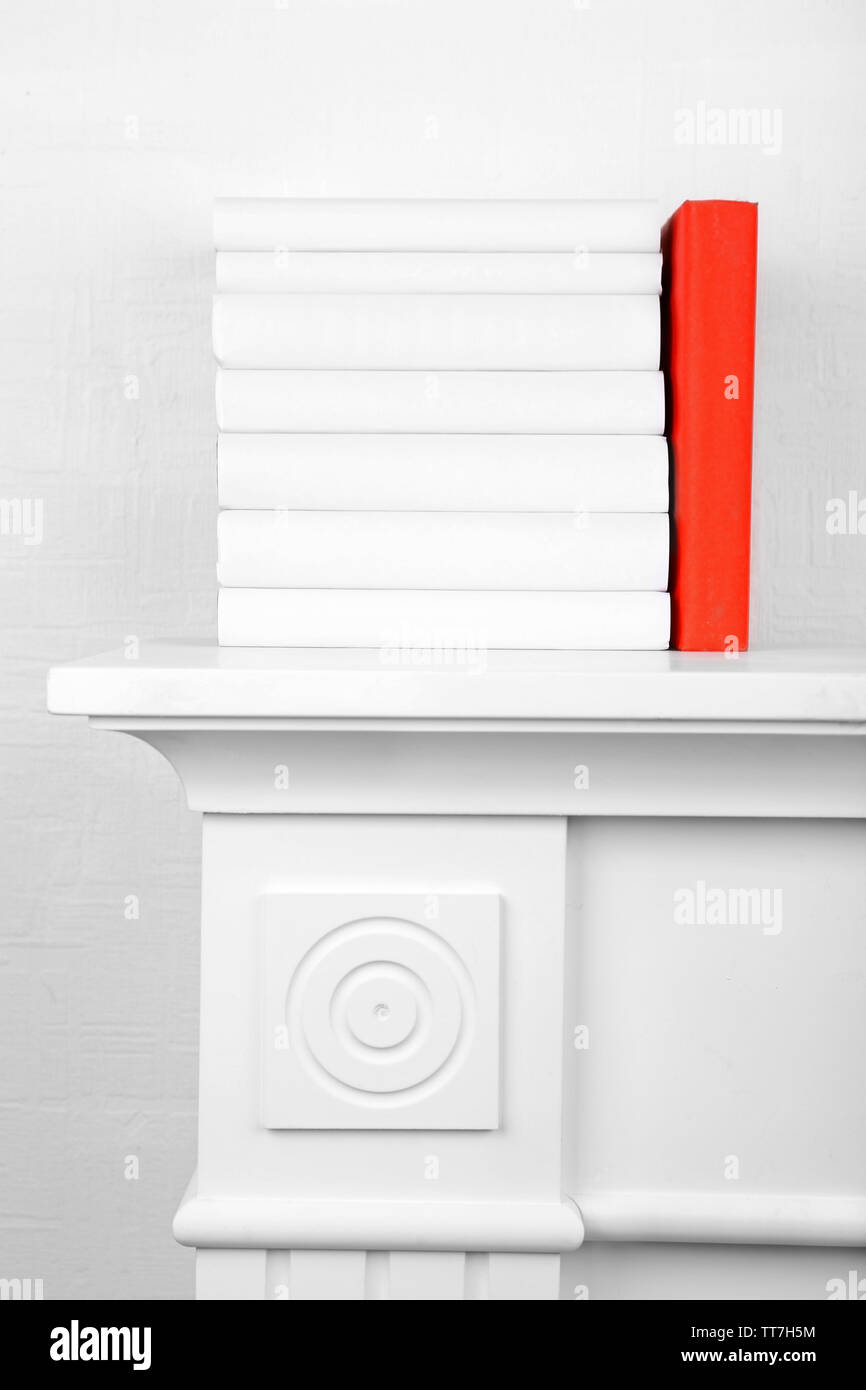 Books on shelf on wall background Stock Photo - Alamy