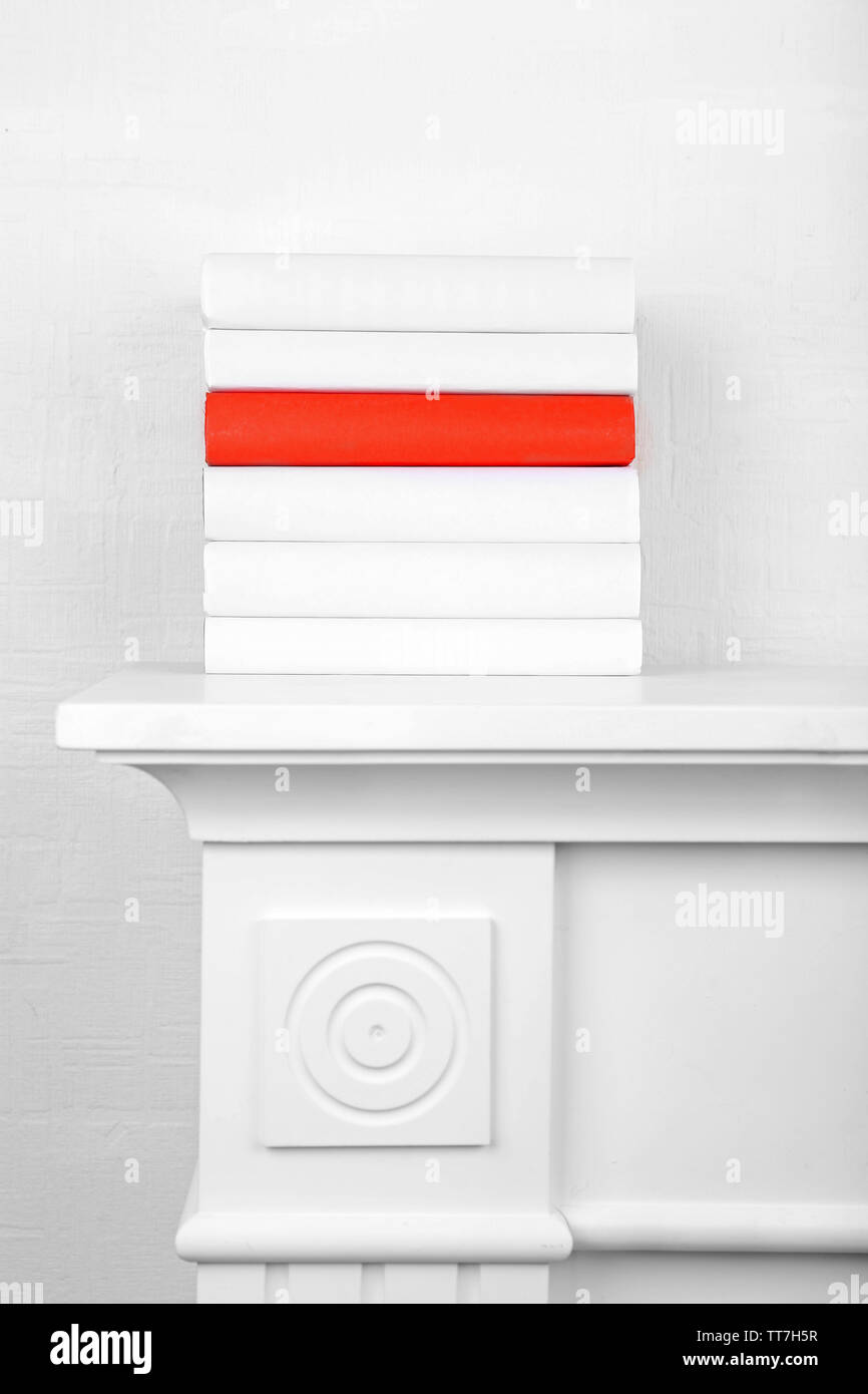 Books on shelf on wall background Stock Photo - Alamy