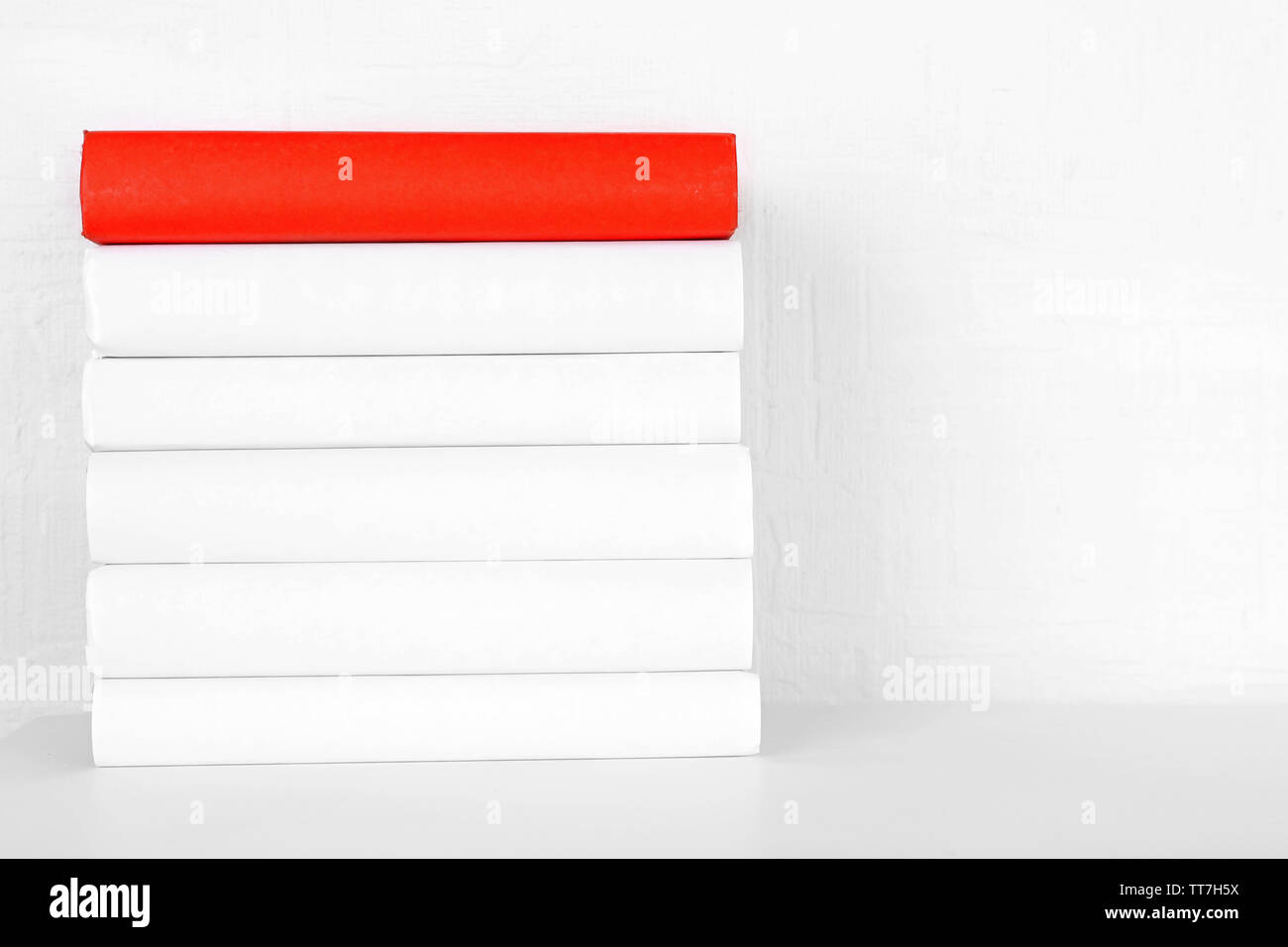 Books on shelf on wall background Stock Photo - Alamy