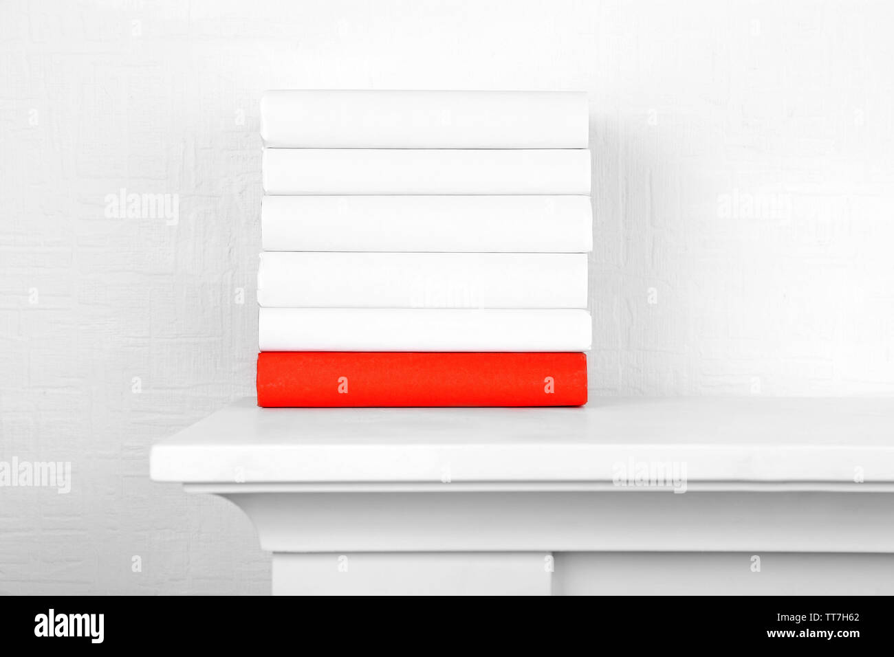 Books on shelf on wall background Stock Photo - Alamy