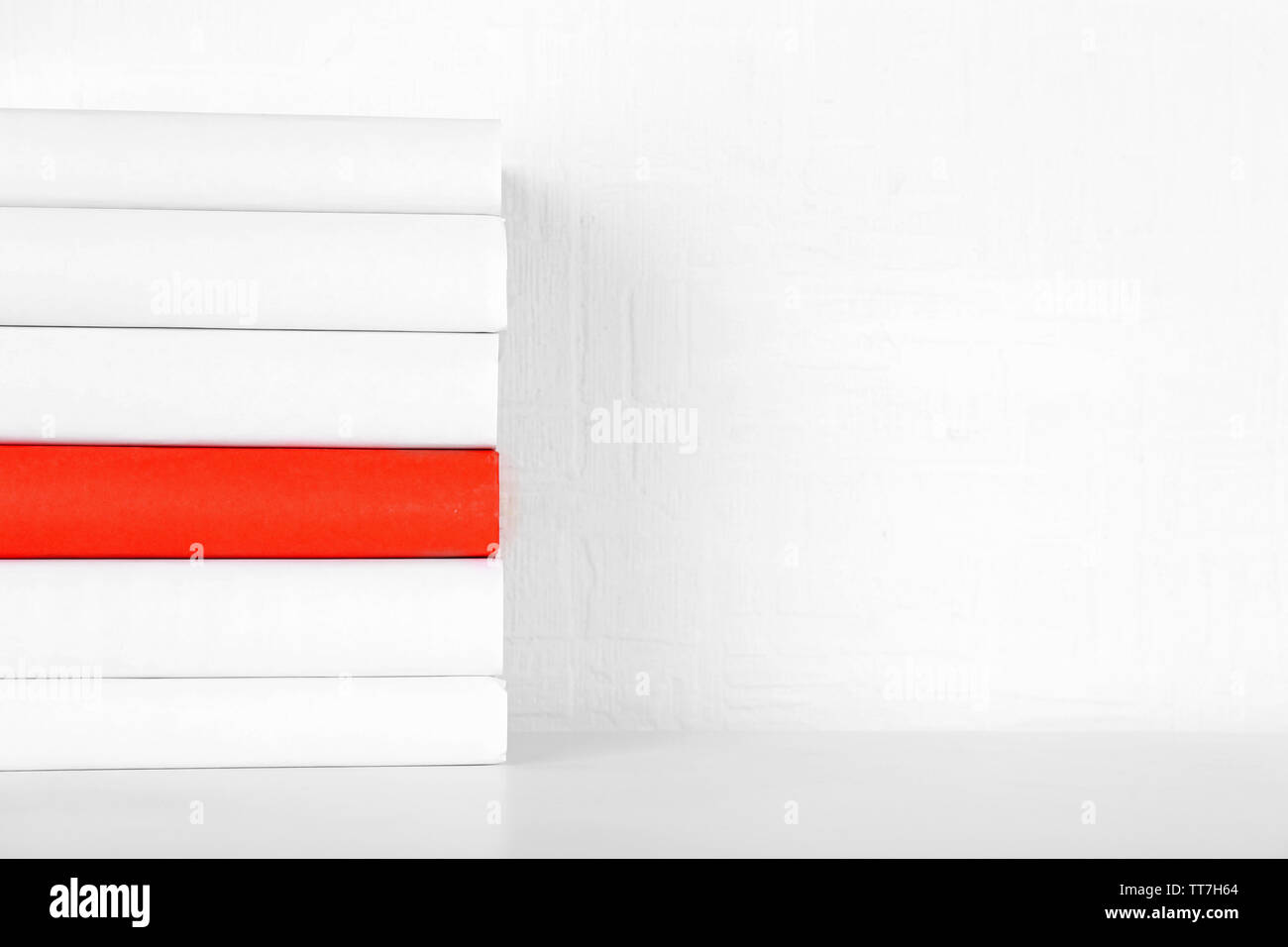 Books on shelf on wall background Stock Photo - Alamy