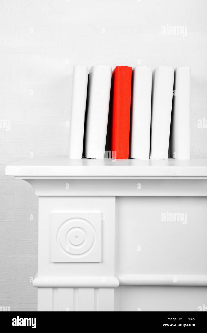 Books on shelf on wall background Stock Photo - Alamy