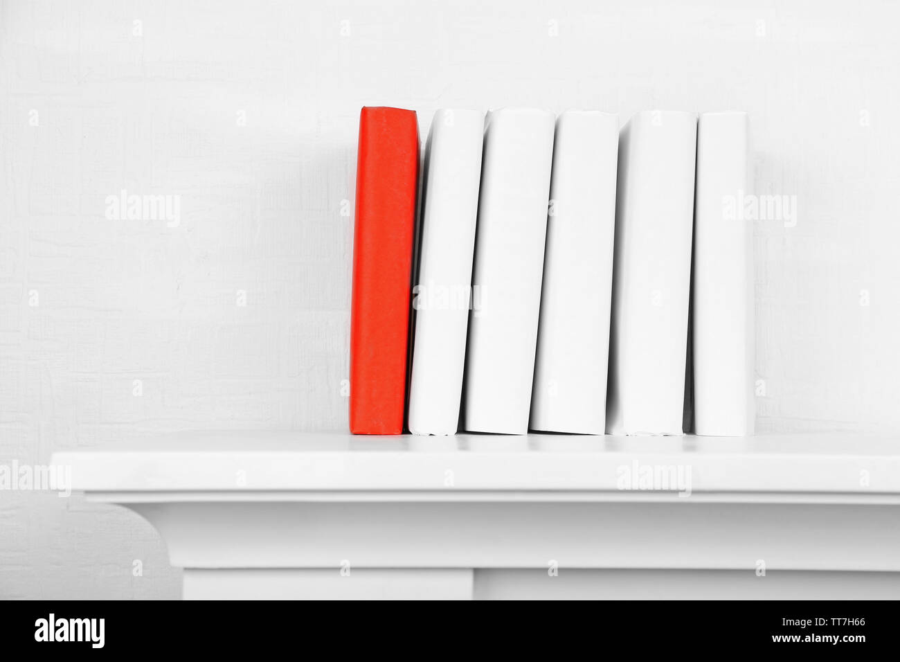 Books on shelf on wall background Stock Photo - Alamy