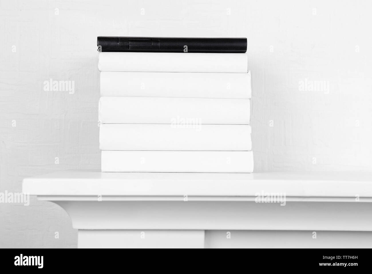 Books on shelf on wall background Stock Photo - Alamy