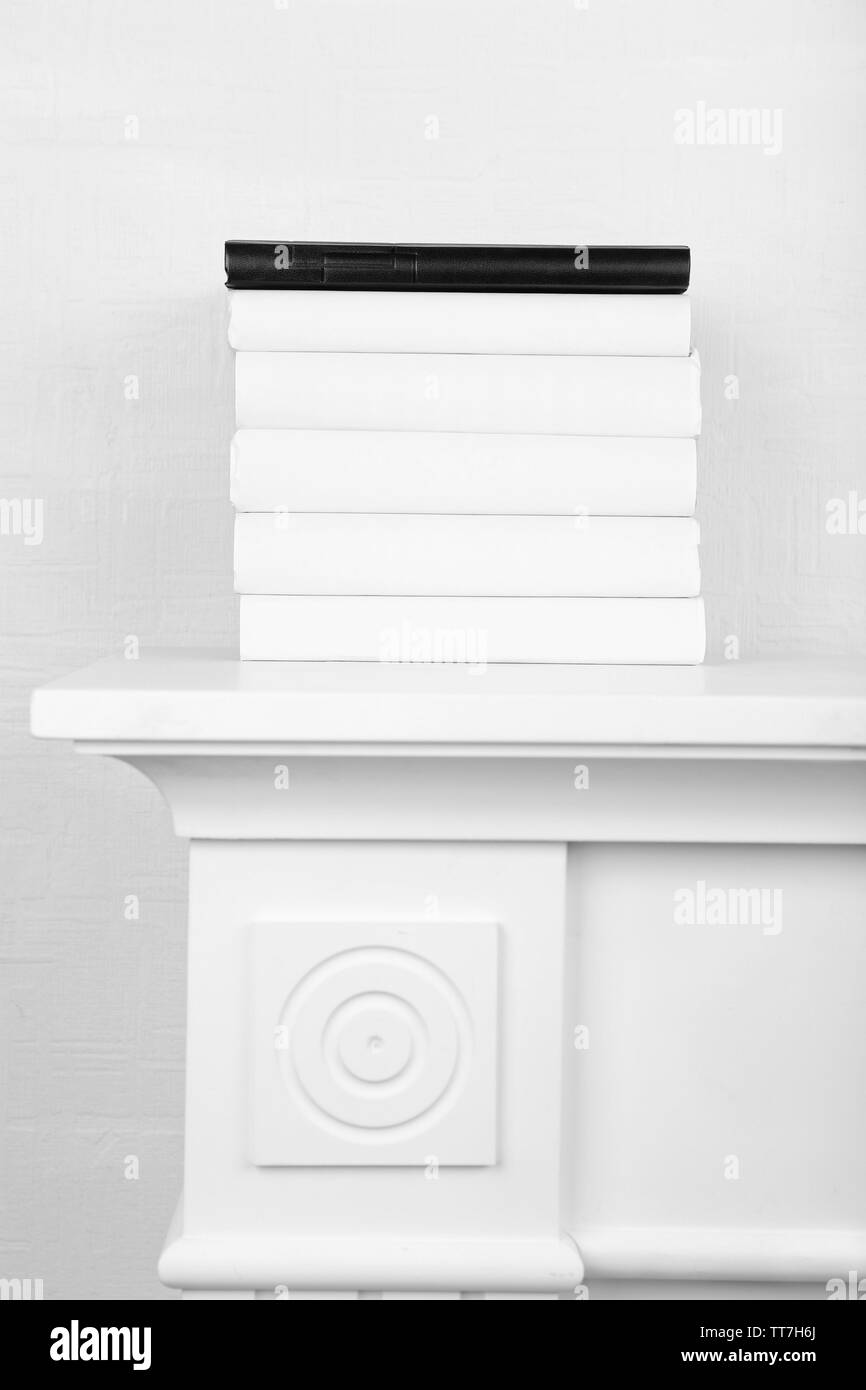 Books on shelf on wall background Stock Photo - Alamy