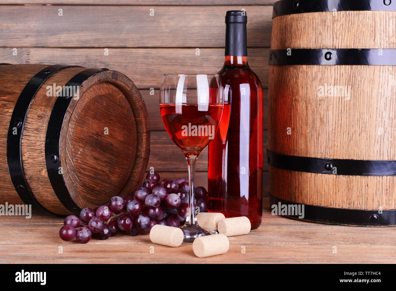 Red wine on table on wooden background Stock Photo - Alamy