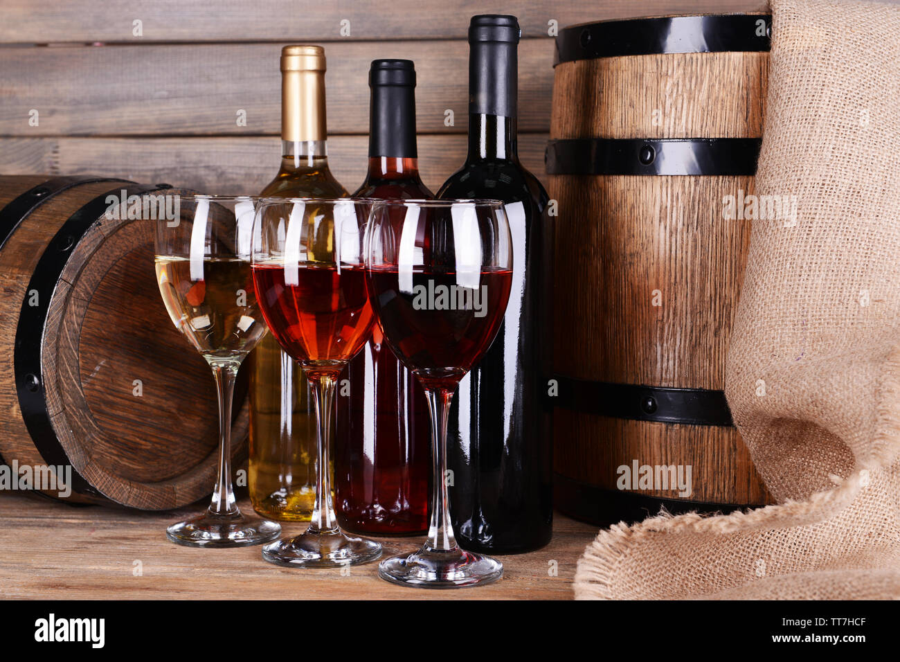 Different wine on table on wooden background Stock Photo - Alamy
