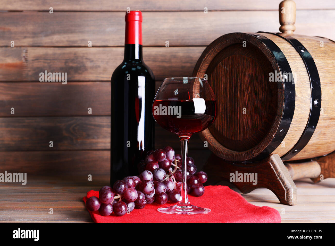 Red wine on table on wooden background Stock Photo - Alamy