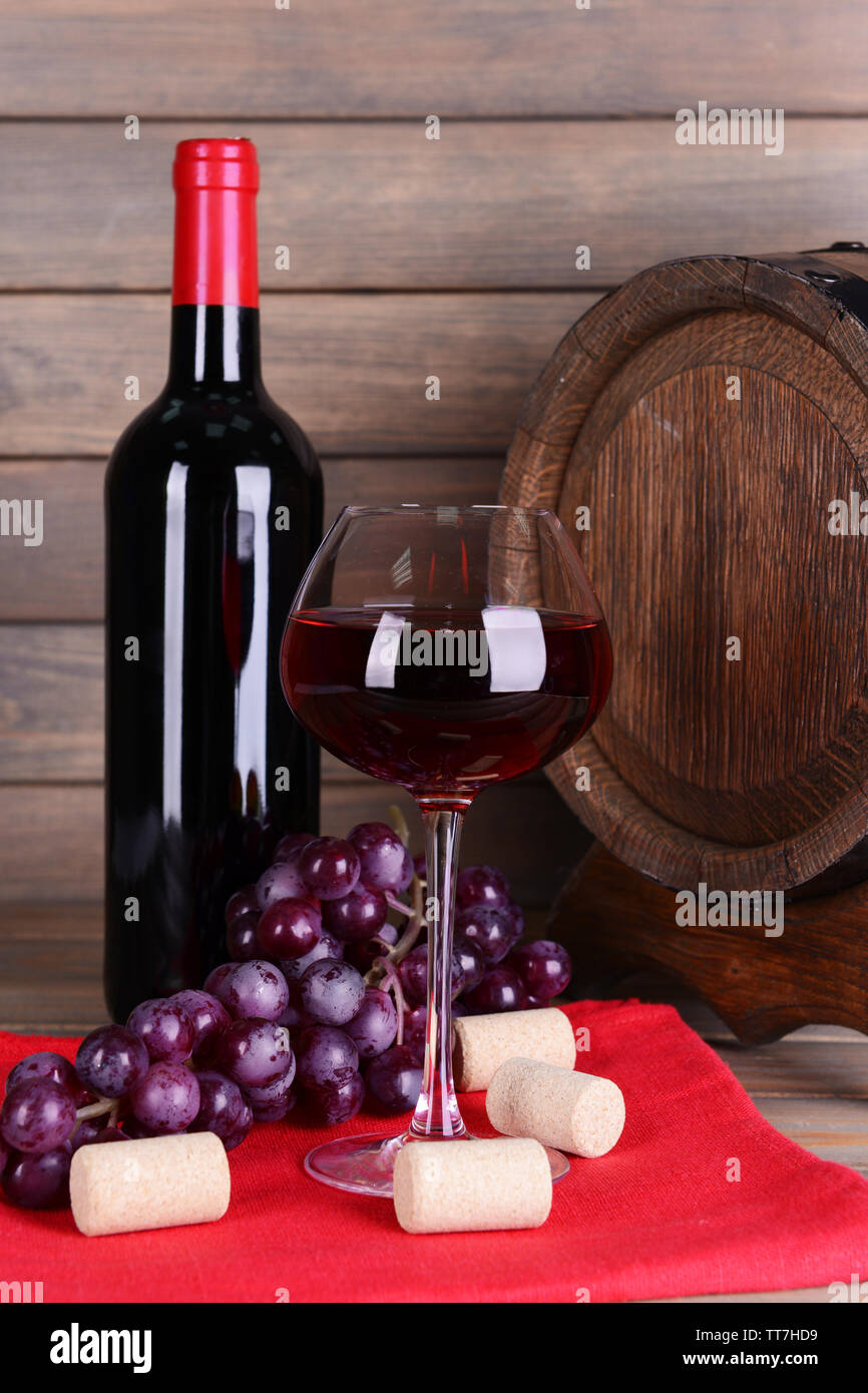 Red wine on table on wooden background Stock Photo - Alamy