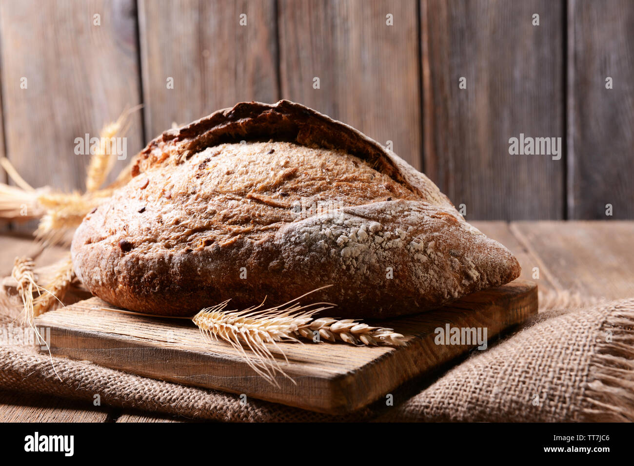 Tasty bread on table on wooden background Stock Photo - Alamy
