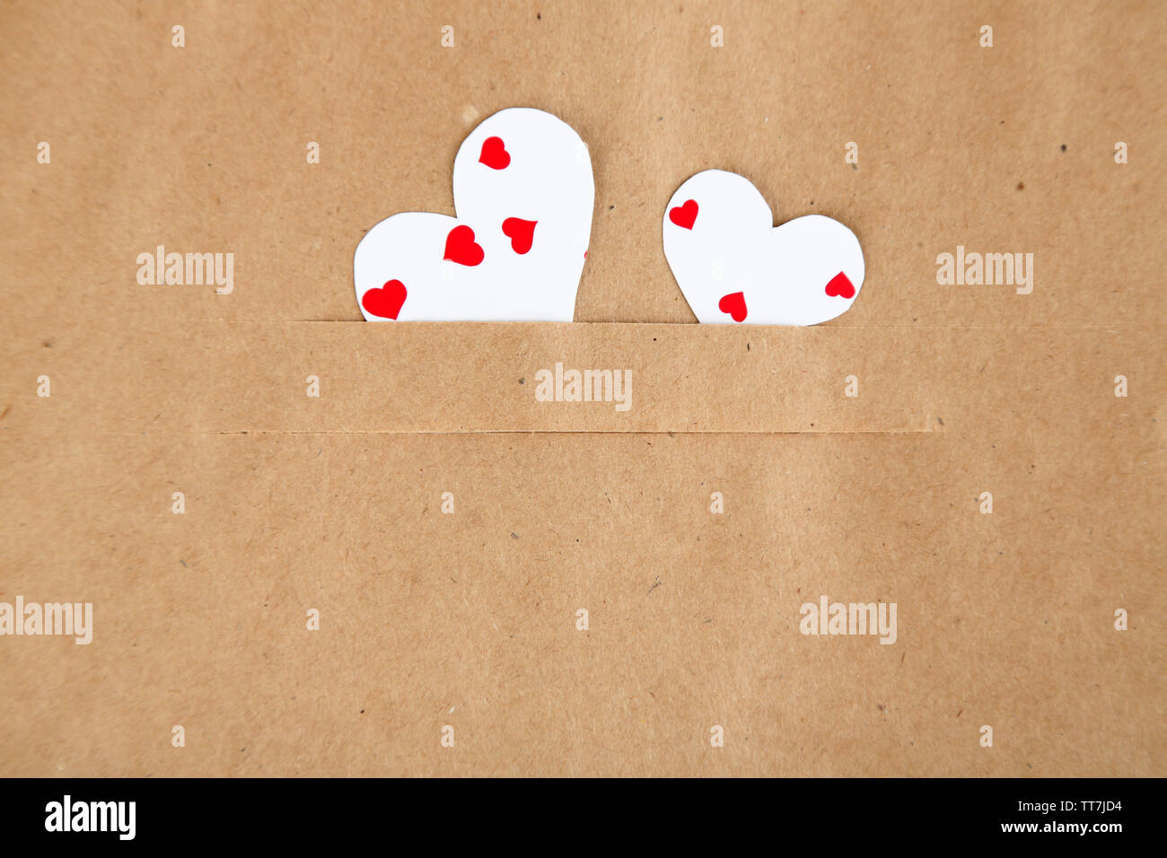 Paper hearts on brown background, close up Stock Photo - Alamy