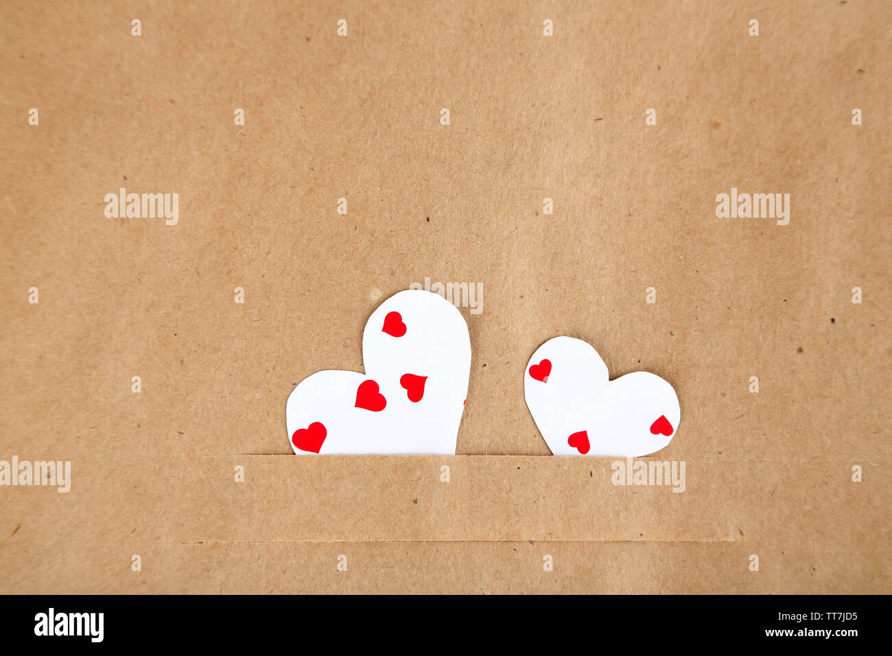 Paper hearts on brown background, close up Stock Photo - Alamy