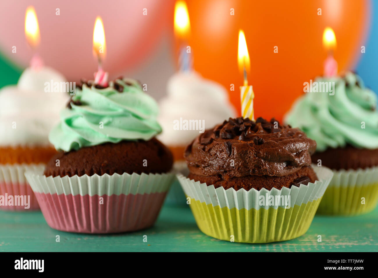 Delicious birthday cupcakes on table on bright background Stock Photo ...
