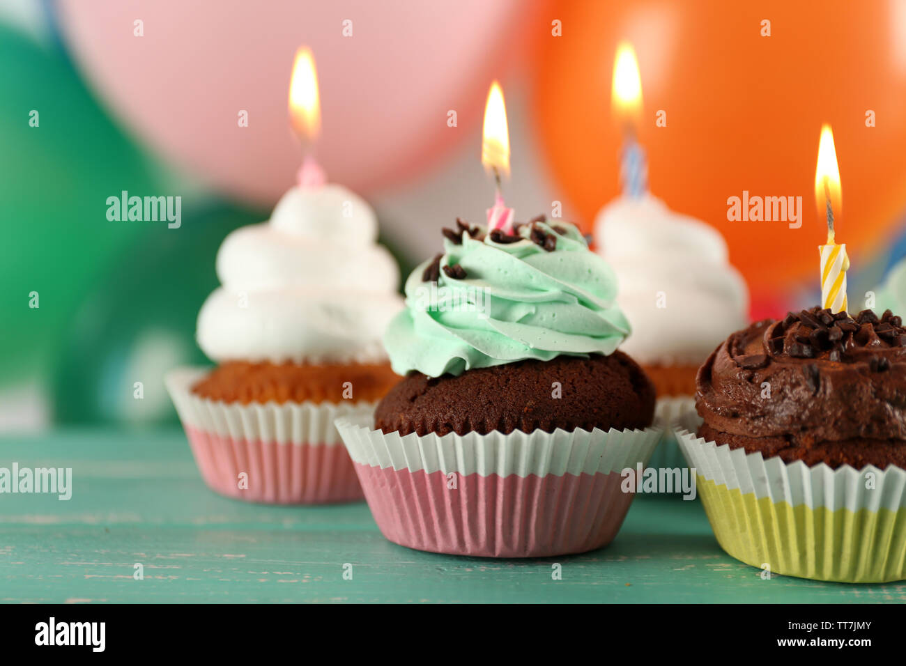 Delicious birthday cupcakes on table on bright background Stock Photo ...