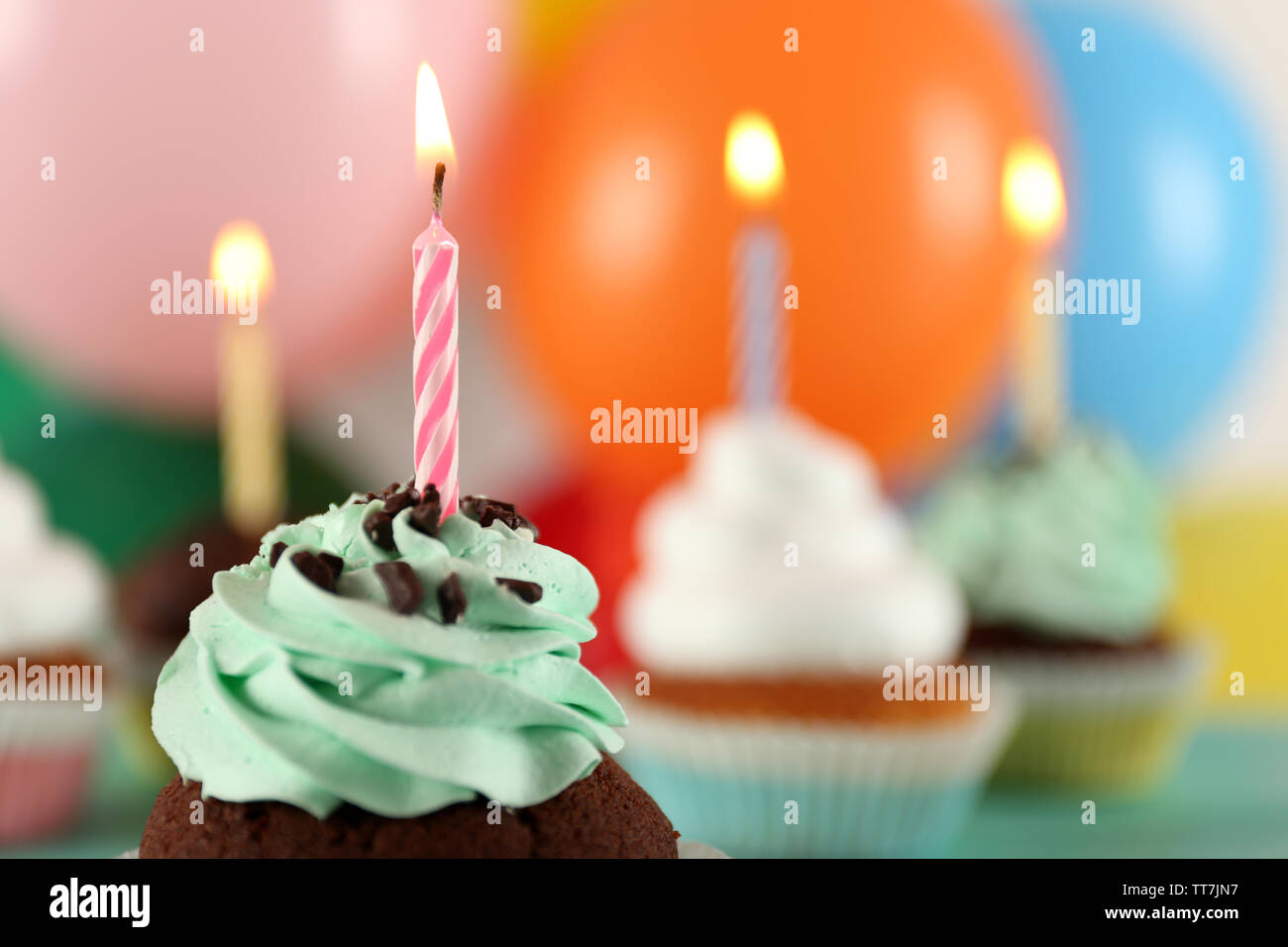 Delicious birthday cupcakes on table on bright background Stock Photo ...