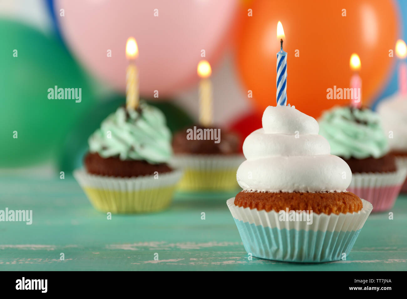 Delicious birthday cupcakes on table on bright background Stock Photo ...