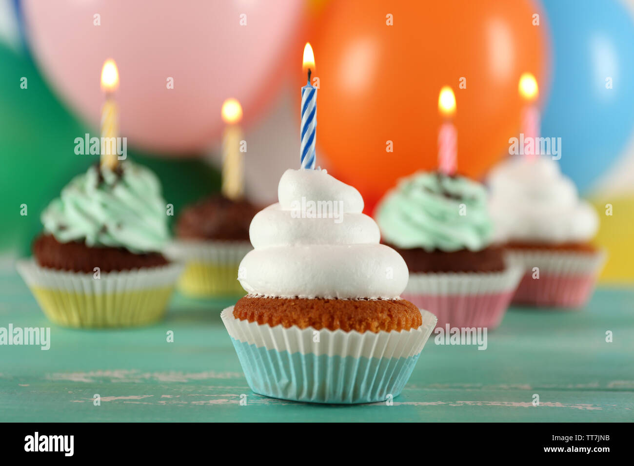 Delicious birthday cupcakes on table on bright background Stock Photo ...
