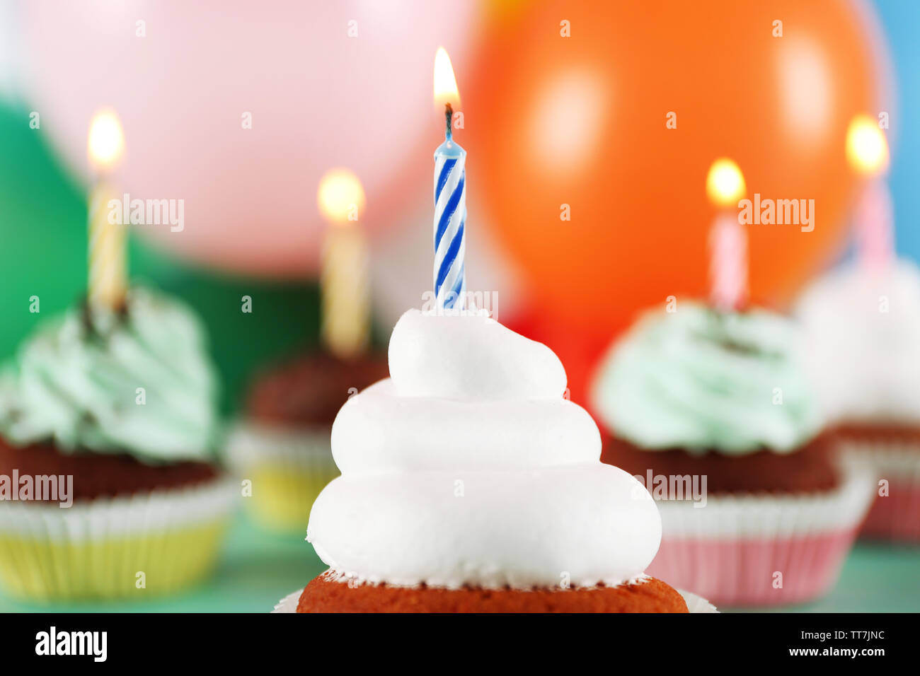 Delicious birthday cupcakes on table on bright background Stock Photo ...