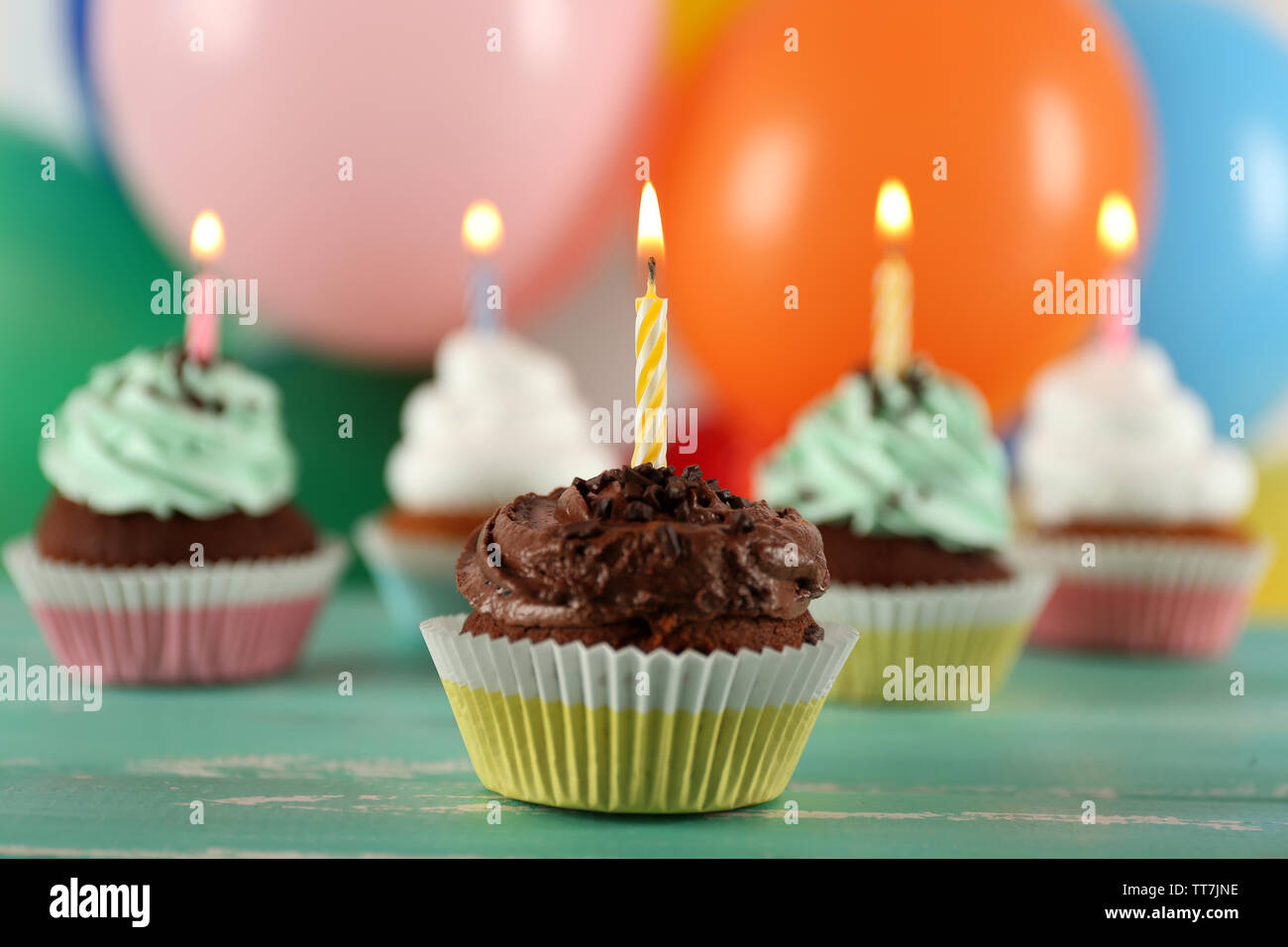 Delicious birthday cupcakes on table on bright background Stock Photo ...