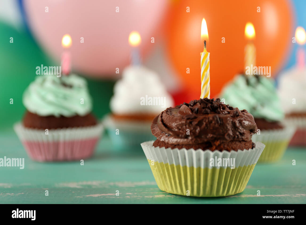 Delicious birthday cupcakes on table on bright background Stock Photo ...