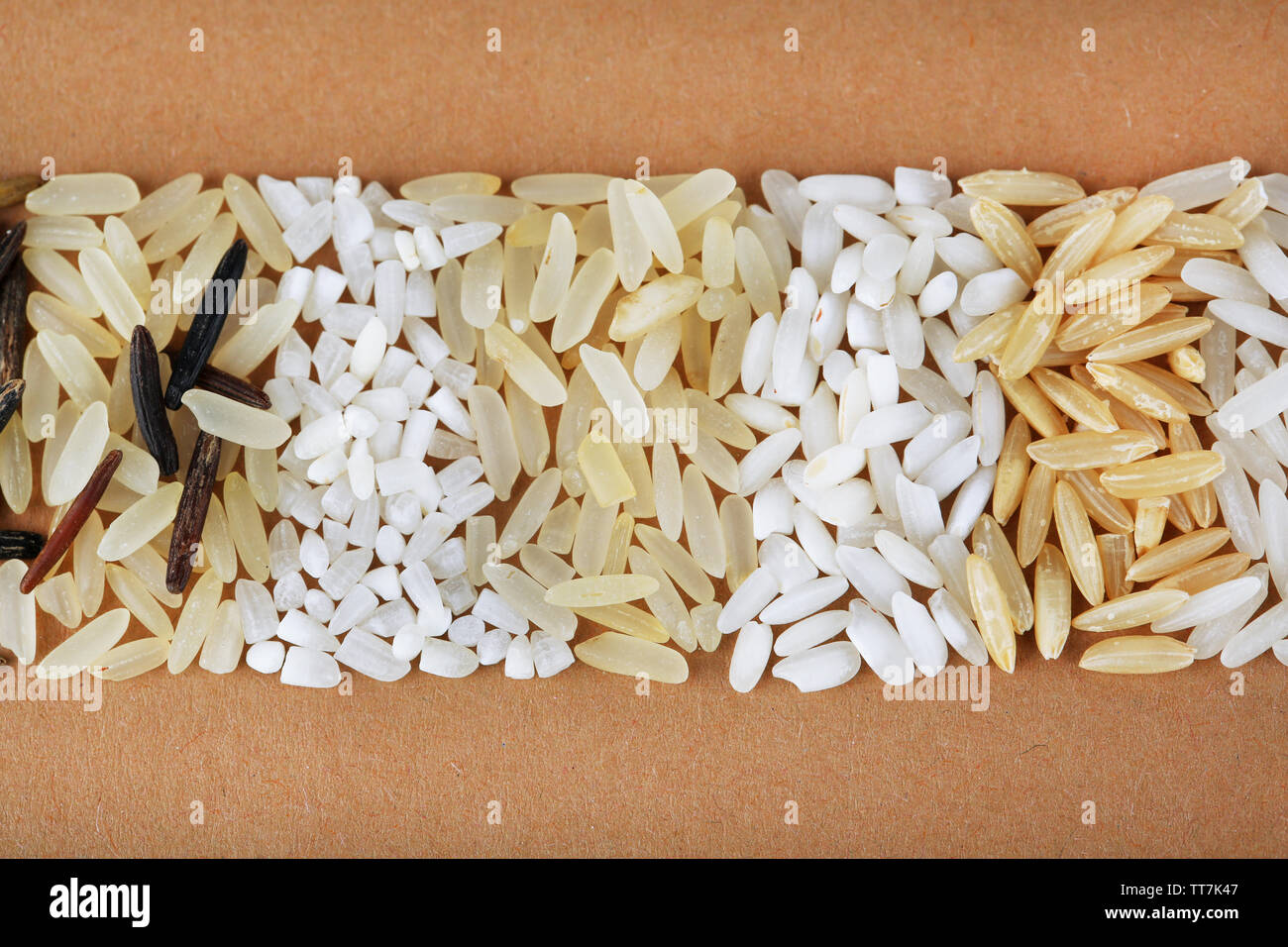 different types of rice on brown background Stock Photo - Alamy