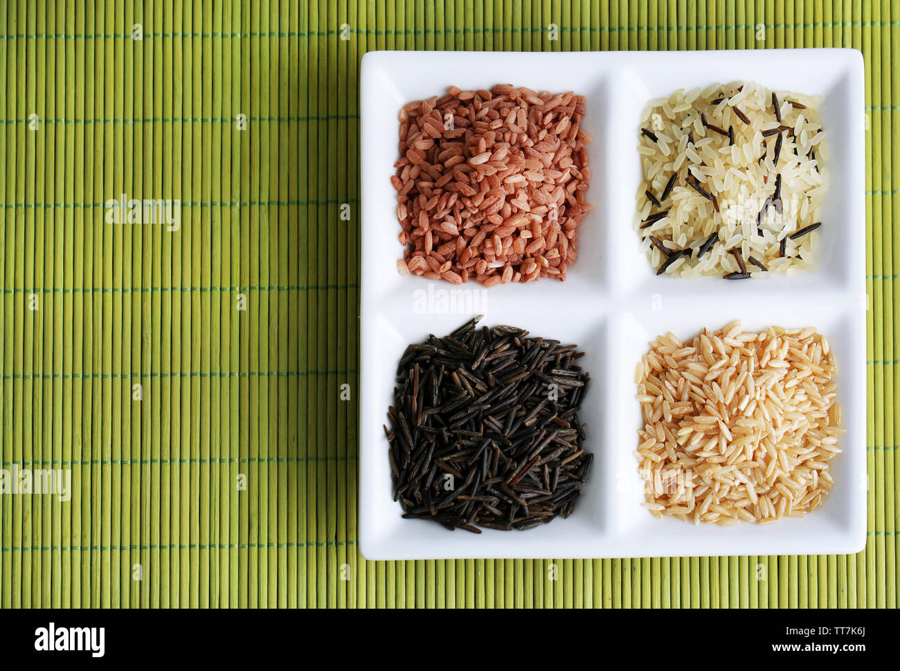 Different types of rice on plate on bamboo background Stock Photo - Alamy