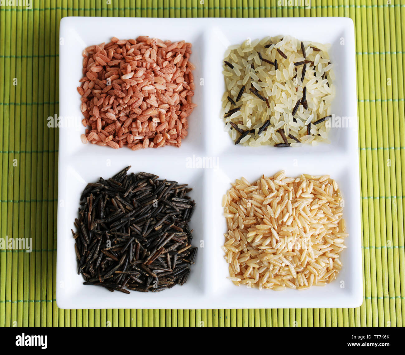Different types of rice on plate on bamboo background Stock Photo - Alamy