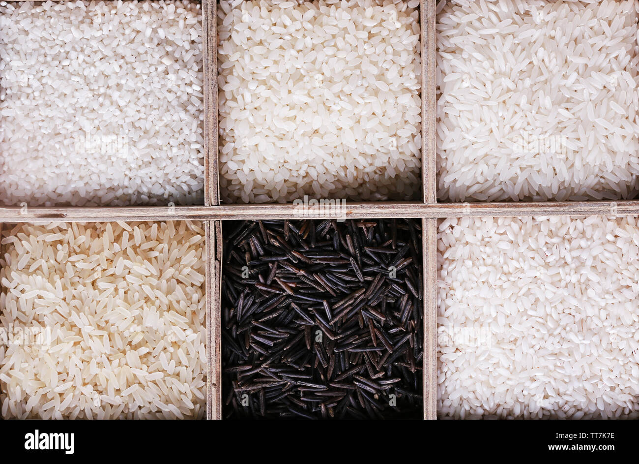 Different types of rice in box on wooden background Stock Photo - Alamy