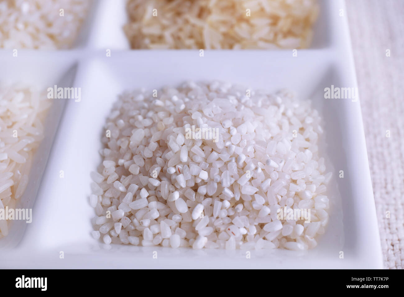 Different types of rice on plate close up Stock Photo - Alamy