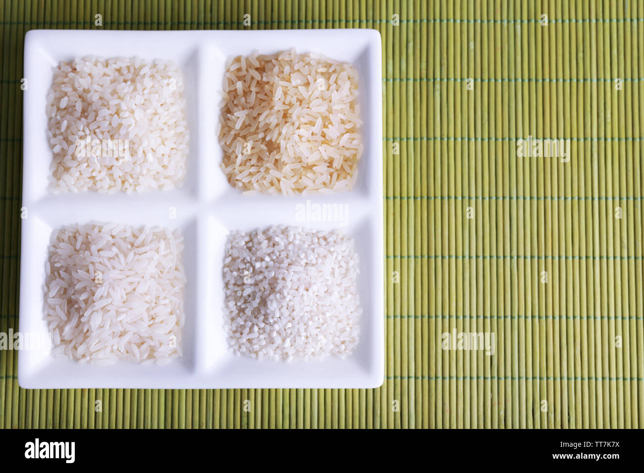 Different types of rice on plate on bamboo background Stock Photo - Alamy
