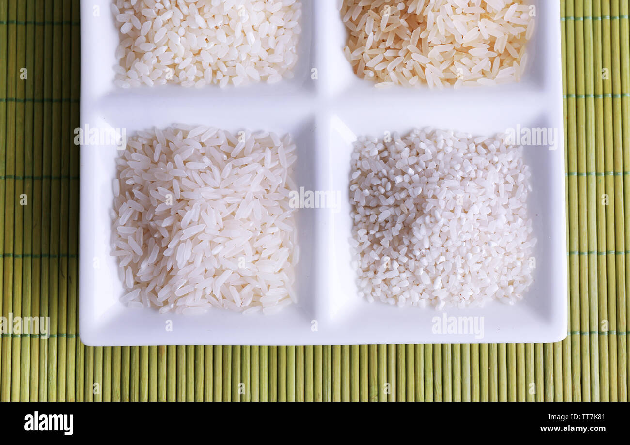 Different types of rice on plate on bamboo background Stock Photo - Alamy