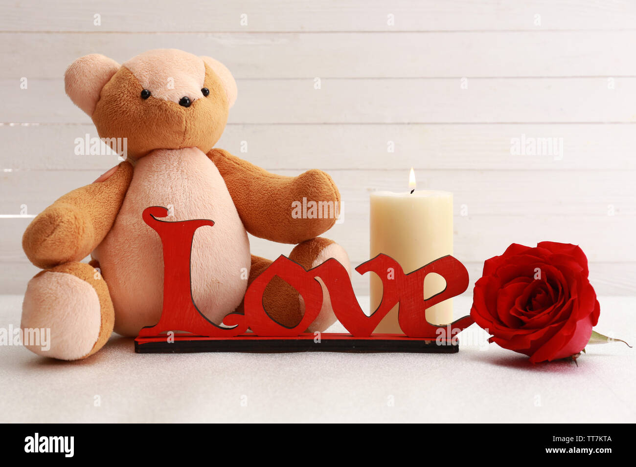 Teddy bear with candle and rose, love concept Stock Photo - Alamy