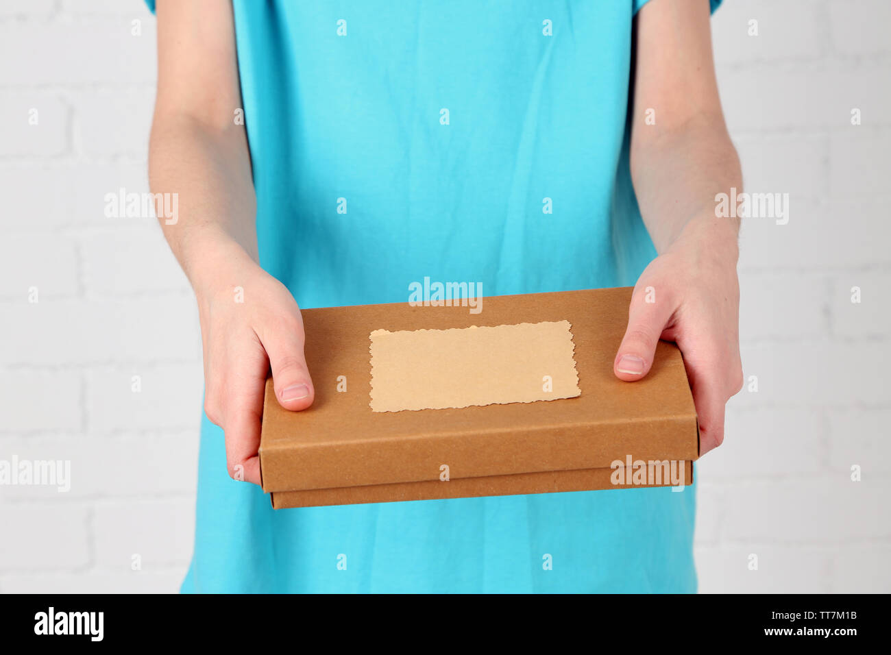 Courier with parcel box Stock Photo - Alamy