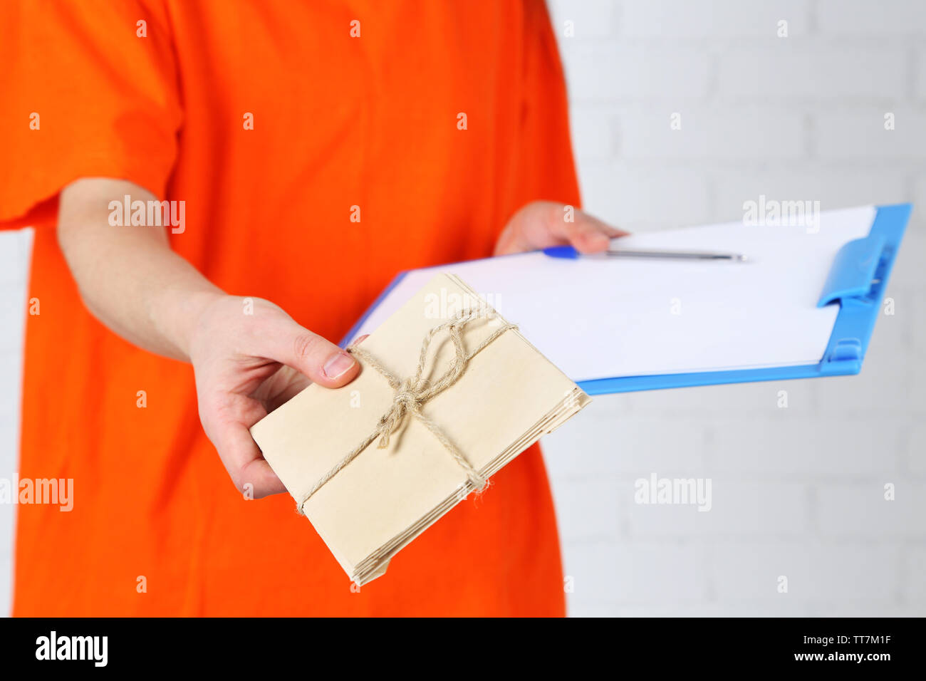 Courier with letter close-up Stock Photo - Alamy