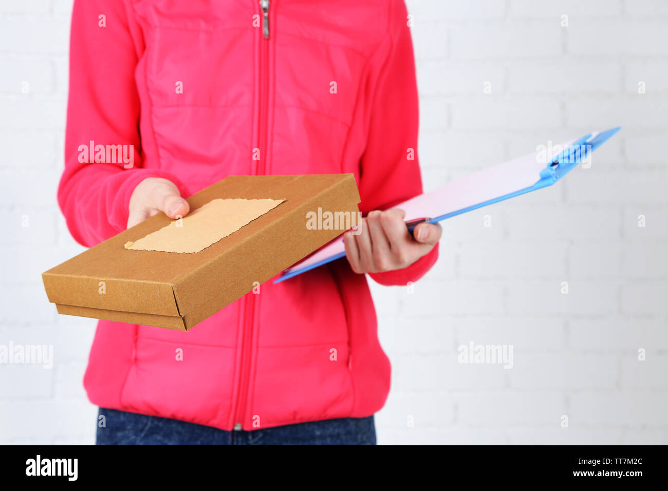 Courier with parcel box Stock Photo - Alamy