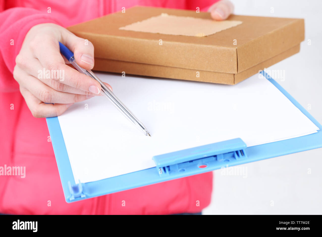 Courier with parcel box Stock Photo - Alamy