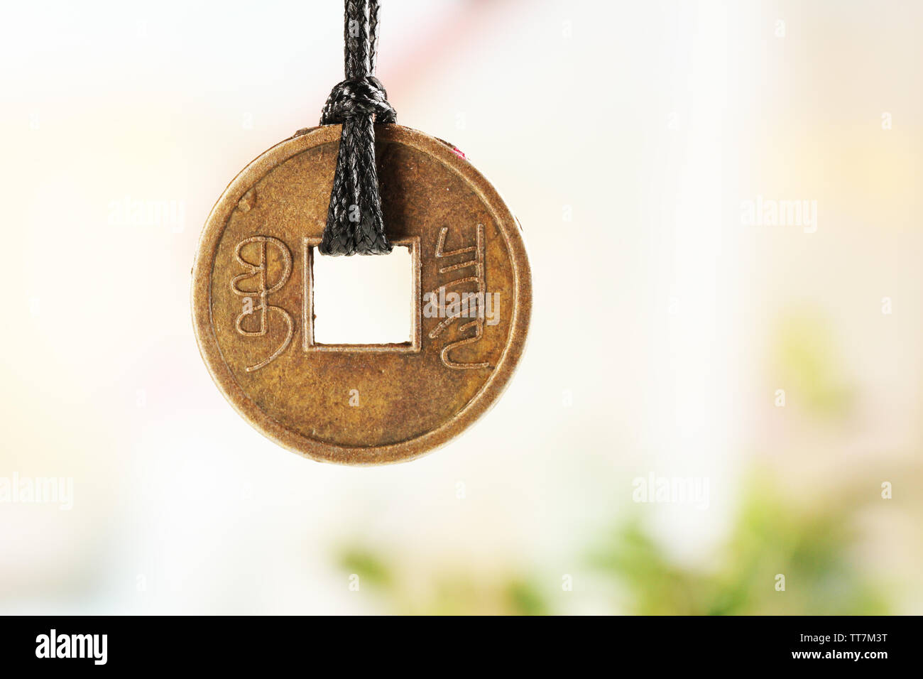 Feng shui coin on light background Stock Photo - Alamy
