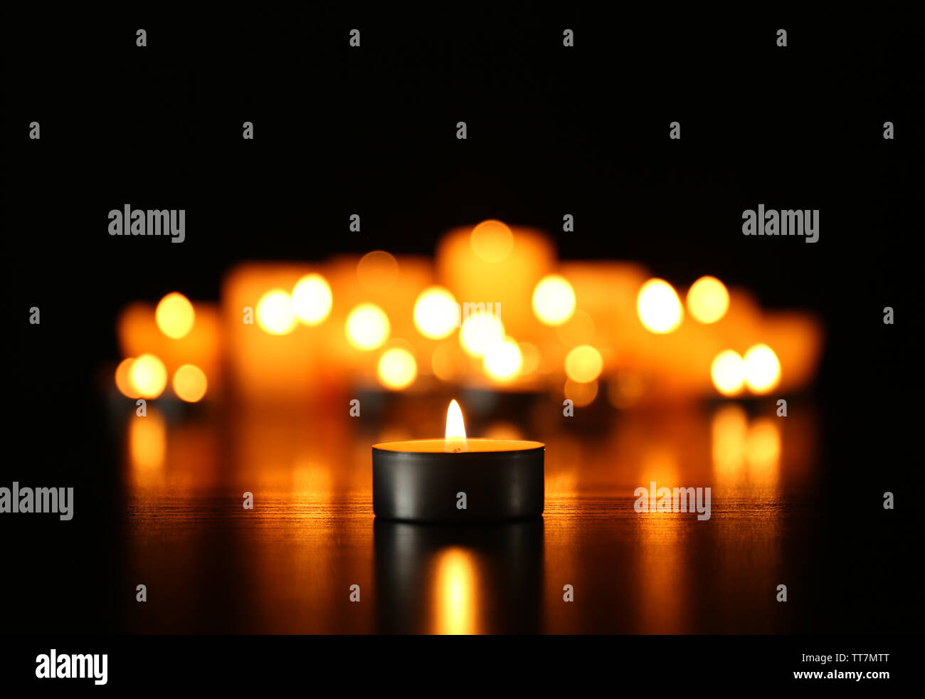 Burning candles on dark background Stock Photo - Alamy