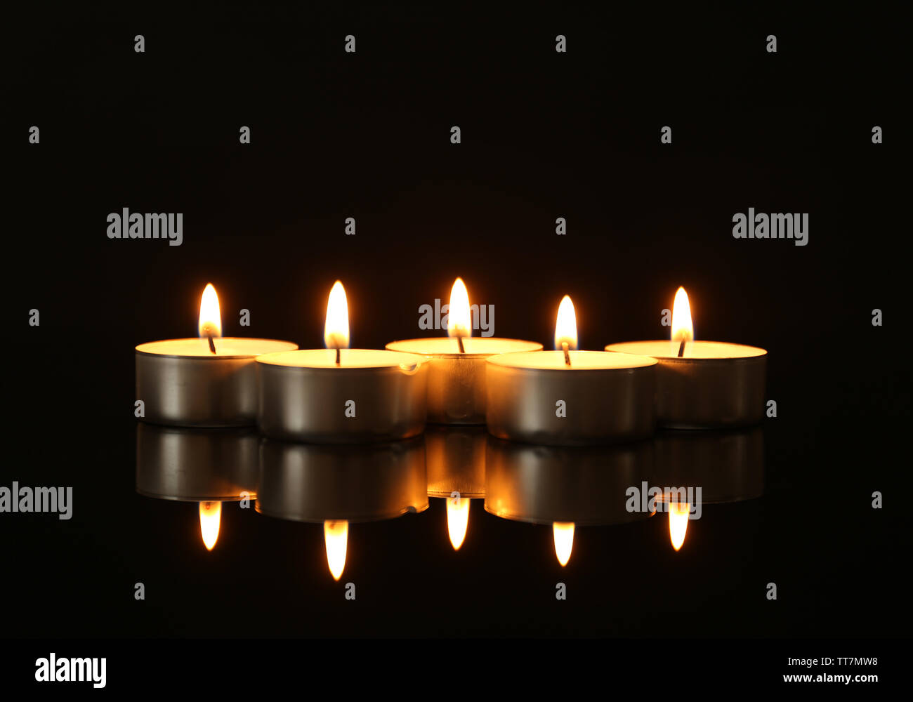Burning candles on dark background Stock Photo - Alamy
