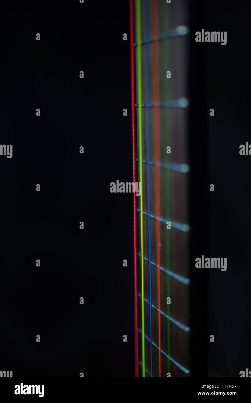 electric acoustic unplugged black guitar with colorful rainbow strings ...