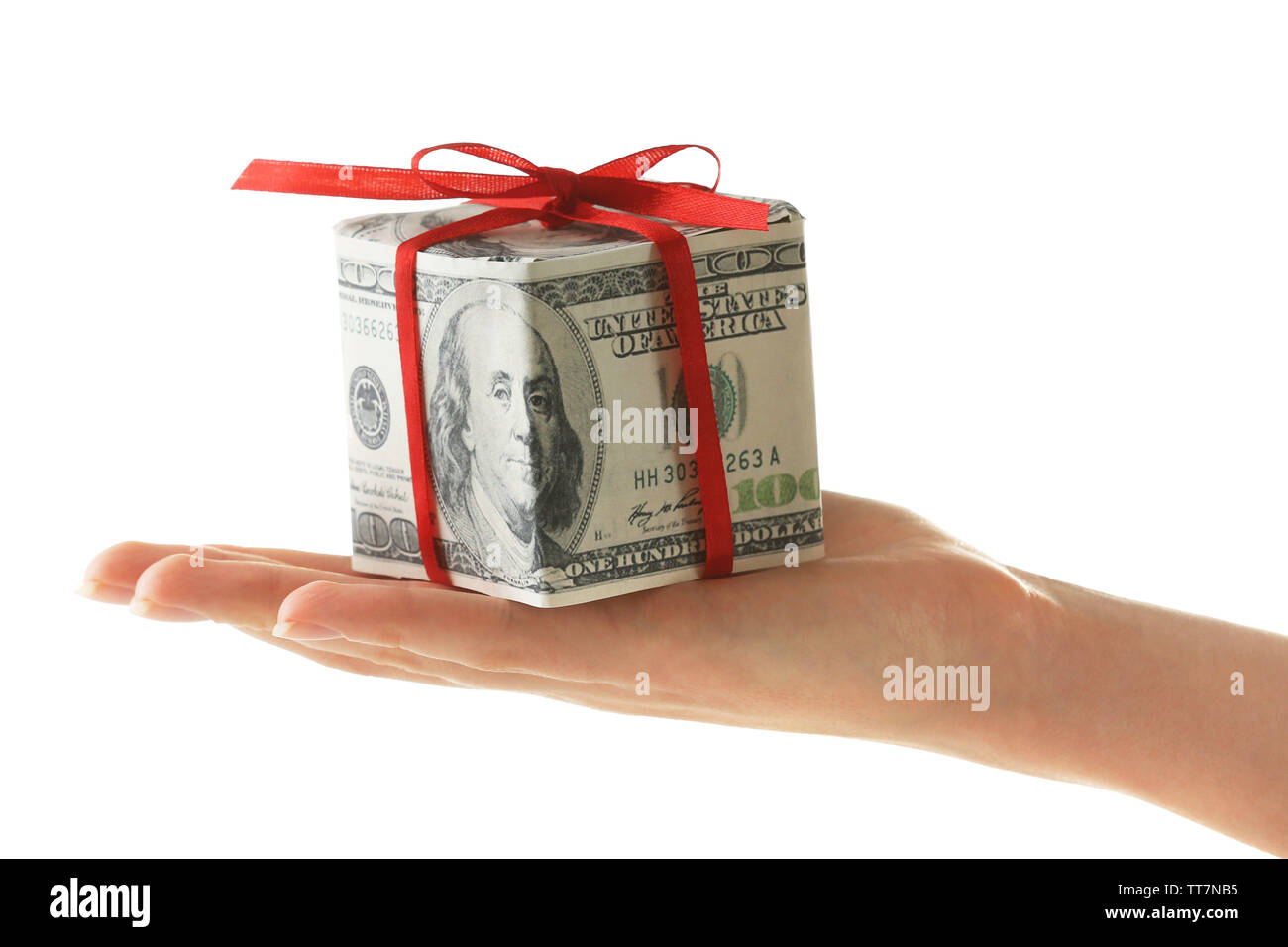 Hand holding dollar gift box with bow isolated on white Stock Photo - Alamy
