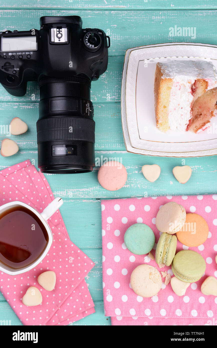 Different sweets and photo camera on table top view Stock Photo - Alamy